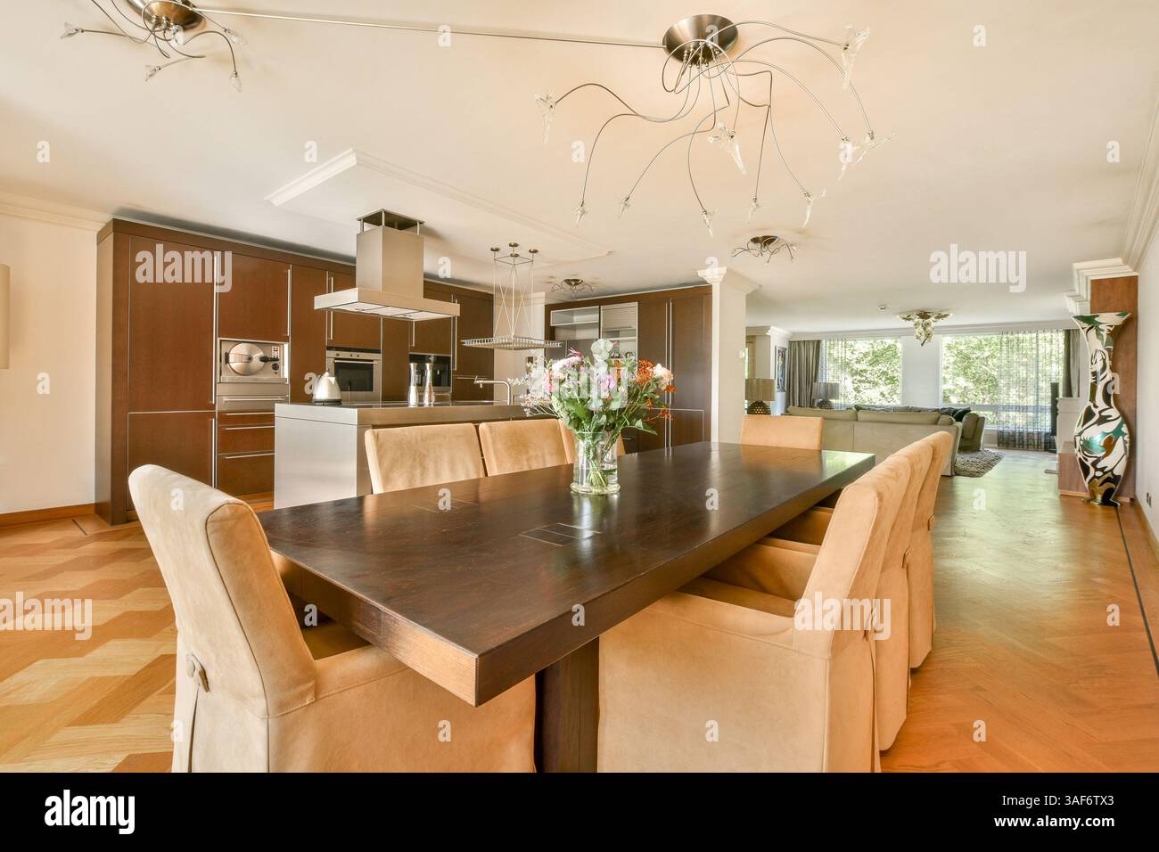 A stylish modern dining area featuring a wooden table, elegant chairs ...