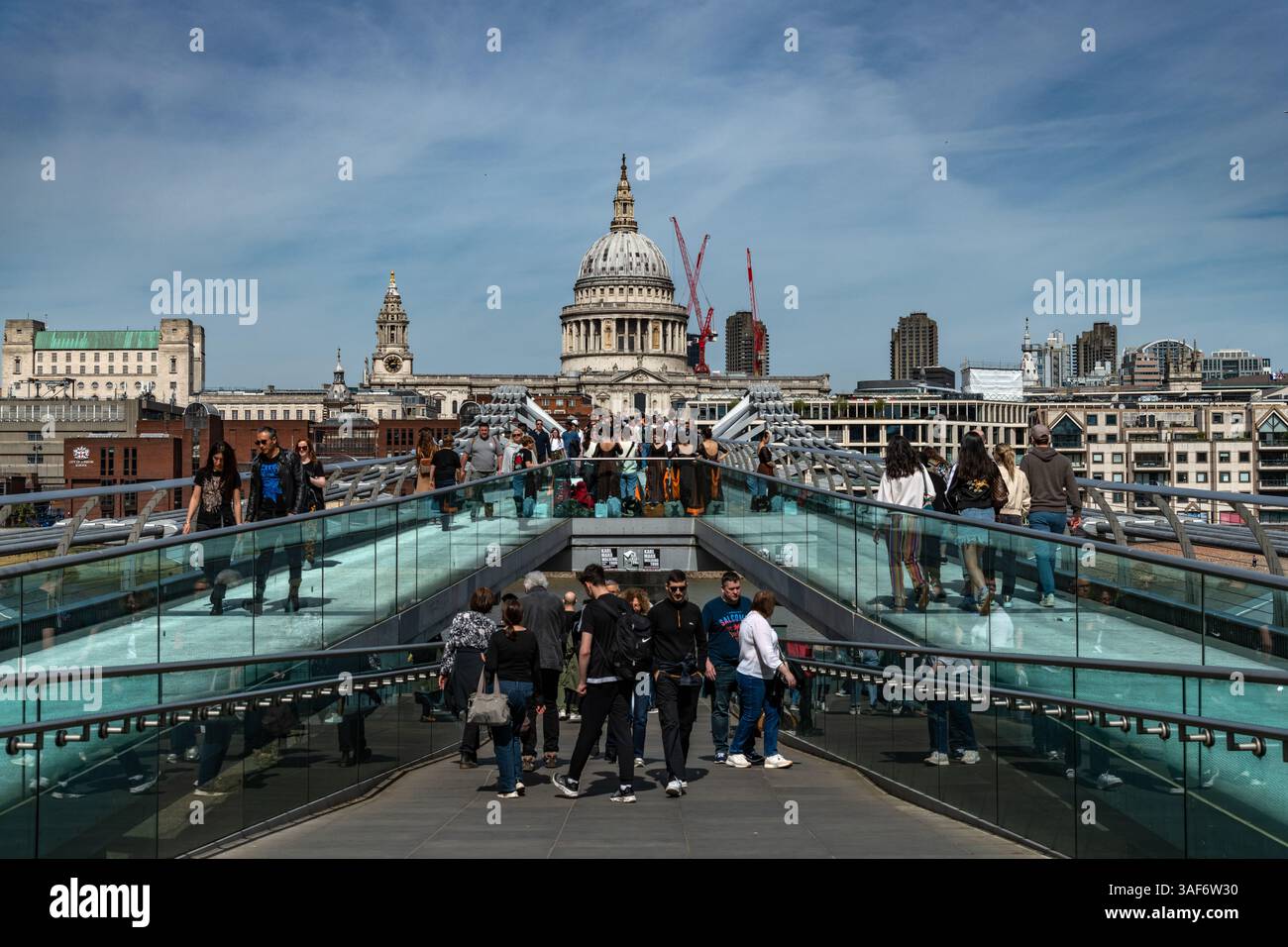 People of the millennium bridge crossing the Thames Stock Photo - Alamy