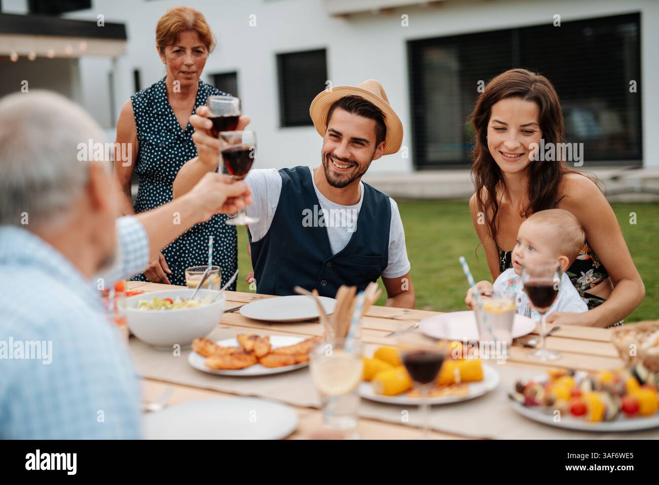 Family toasting with wine during spring family barbecue Stock Photo - Alamy