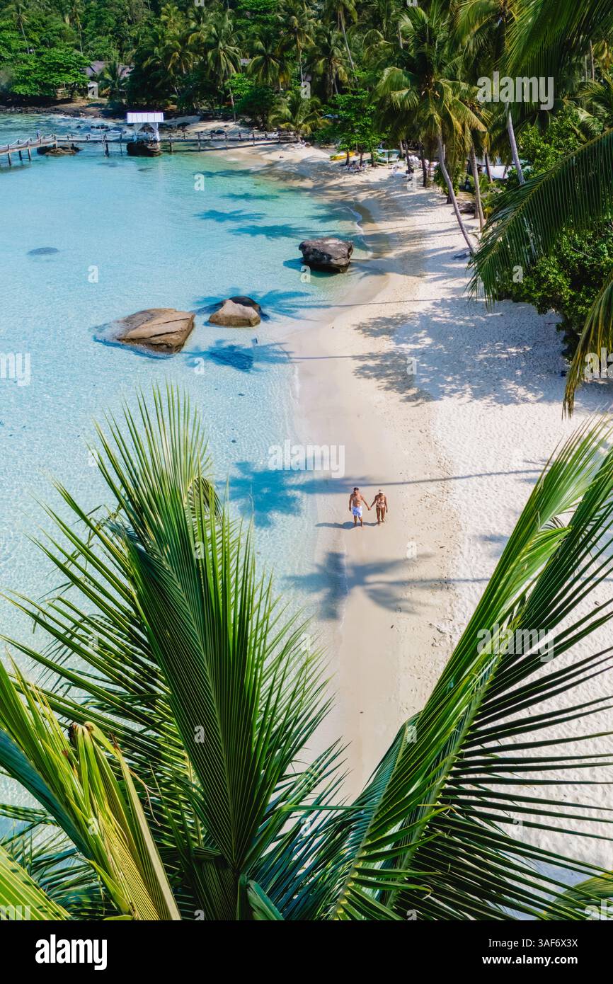 Explore the stunning shores of Koh Kood Island, Thailand, where clear waters meet palm-fringed ...