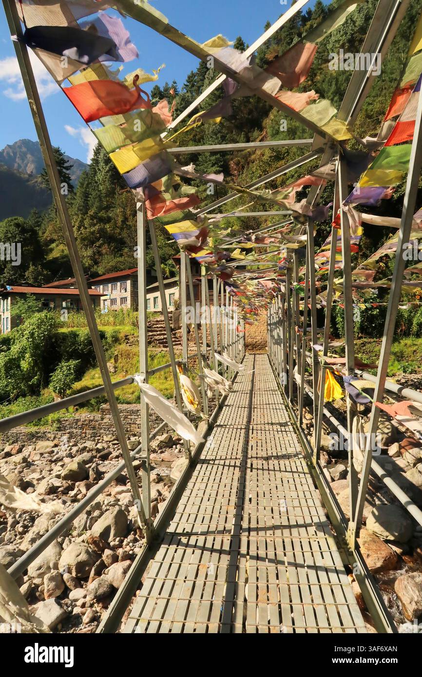 Metal bridge with prayer flags between Salleri and Lukla, Mount Everest ...