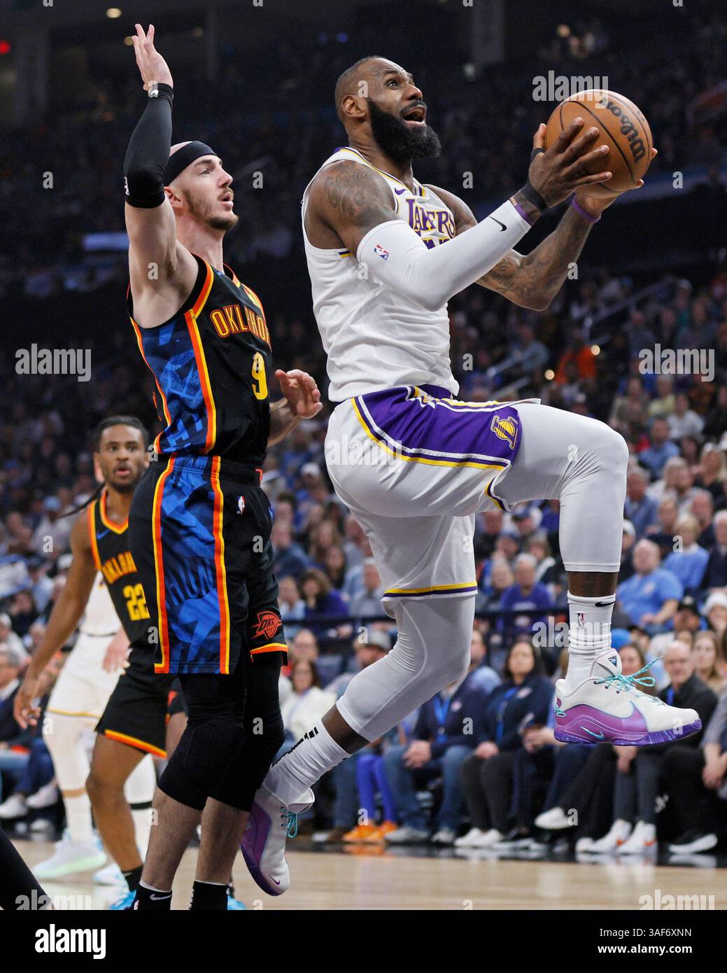 Los Angeles Lakers forward LeBron James, right, goes to the basket in ...