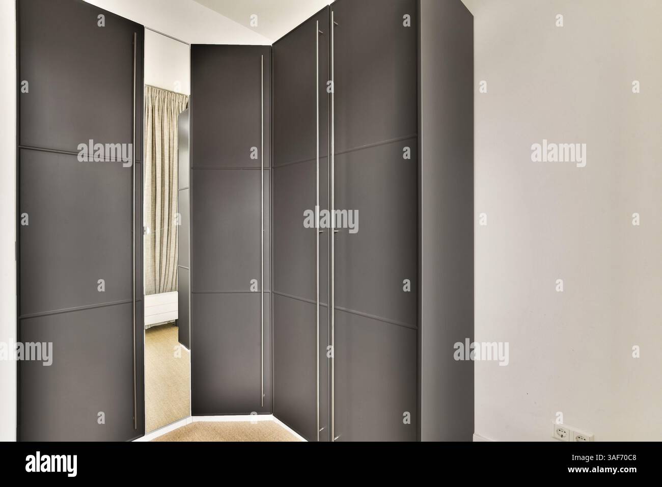 Sleek lines and minimalist design define this modern closet space ...