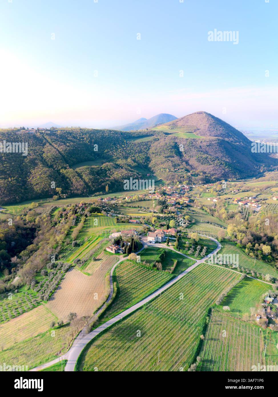 Vertical aerial flyover of rural Italian village Faedo with houses ...