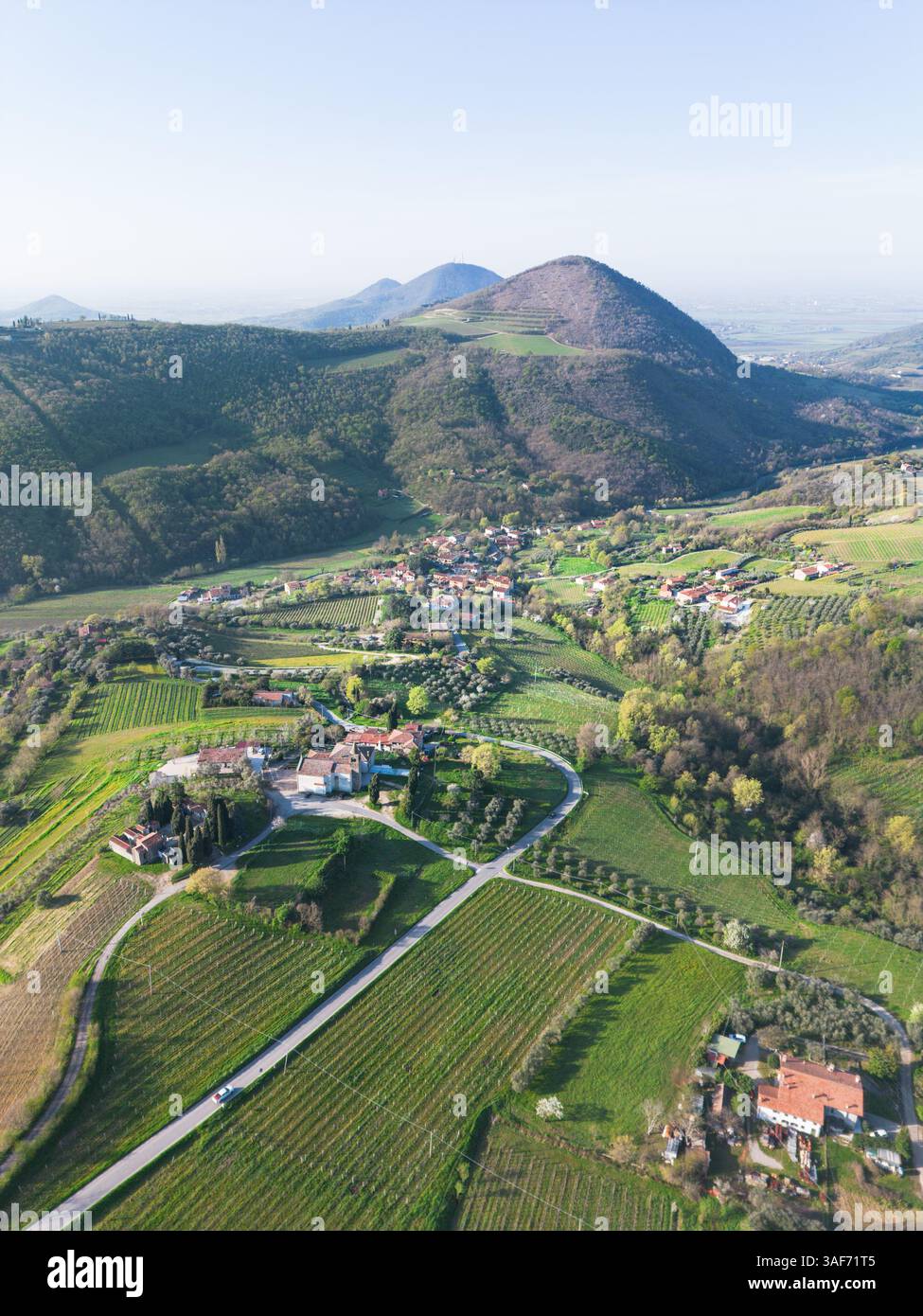 Vertical aerial flyover of rural Italian village Faedo with houses ...