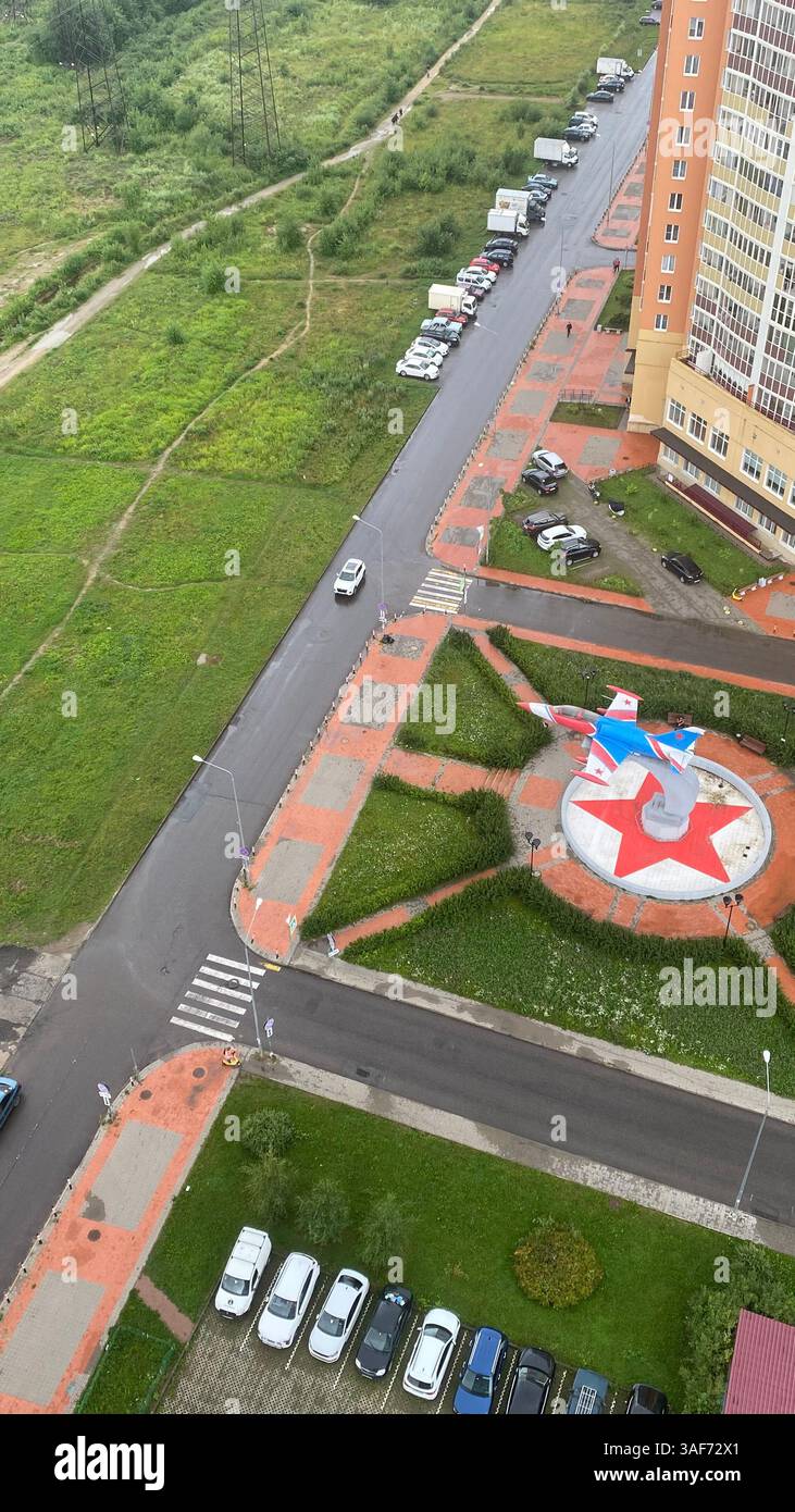 Top-down view of a residential area with a plane monument, green zones ...