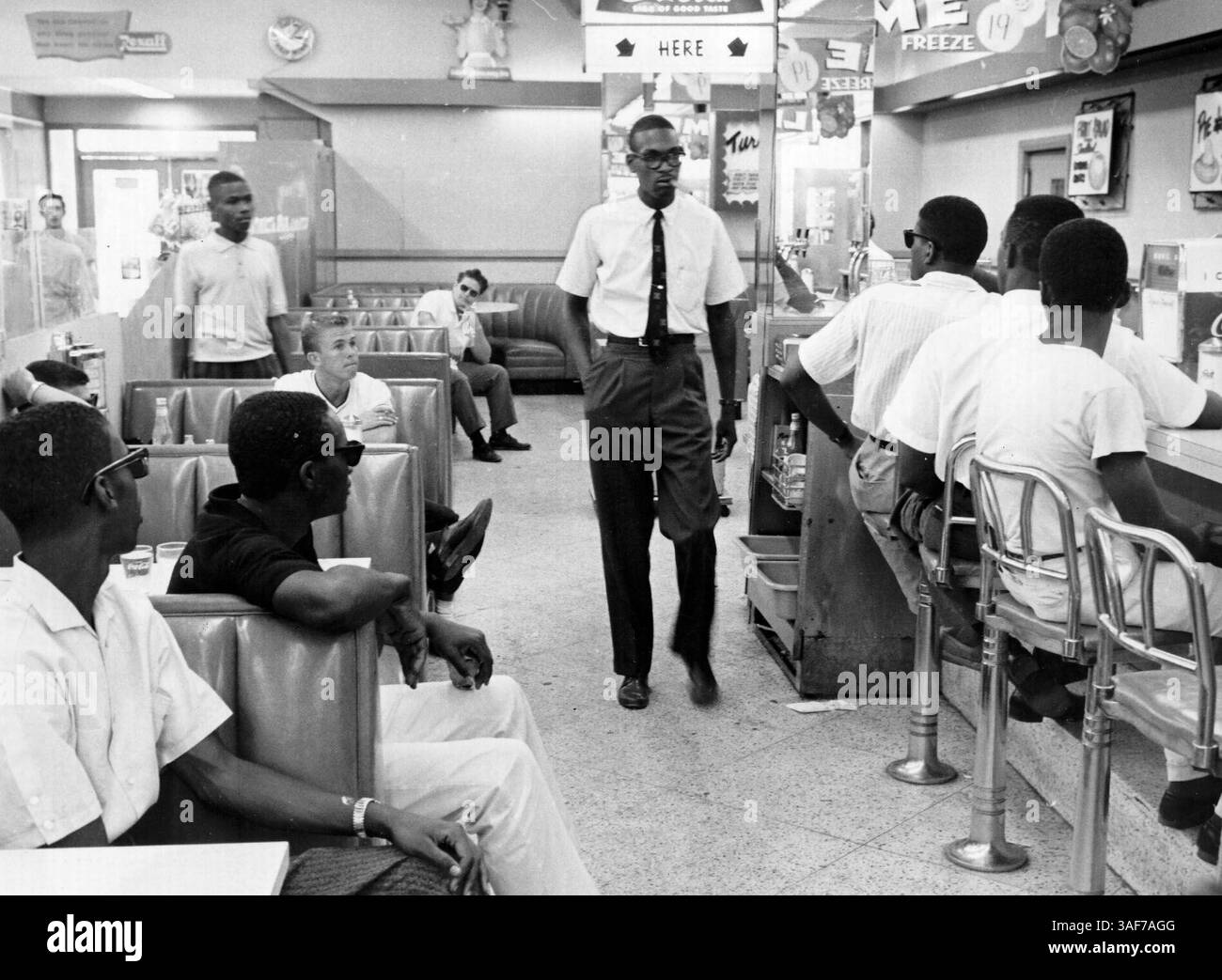 Sit-in leader David Isom puffs a cigar he purchased from one of the ...