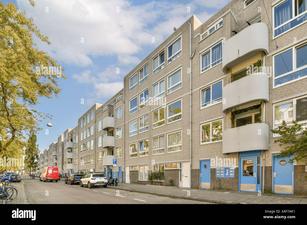 A modern residential building features large windows and balconies ...