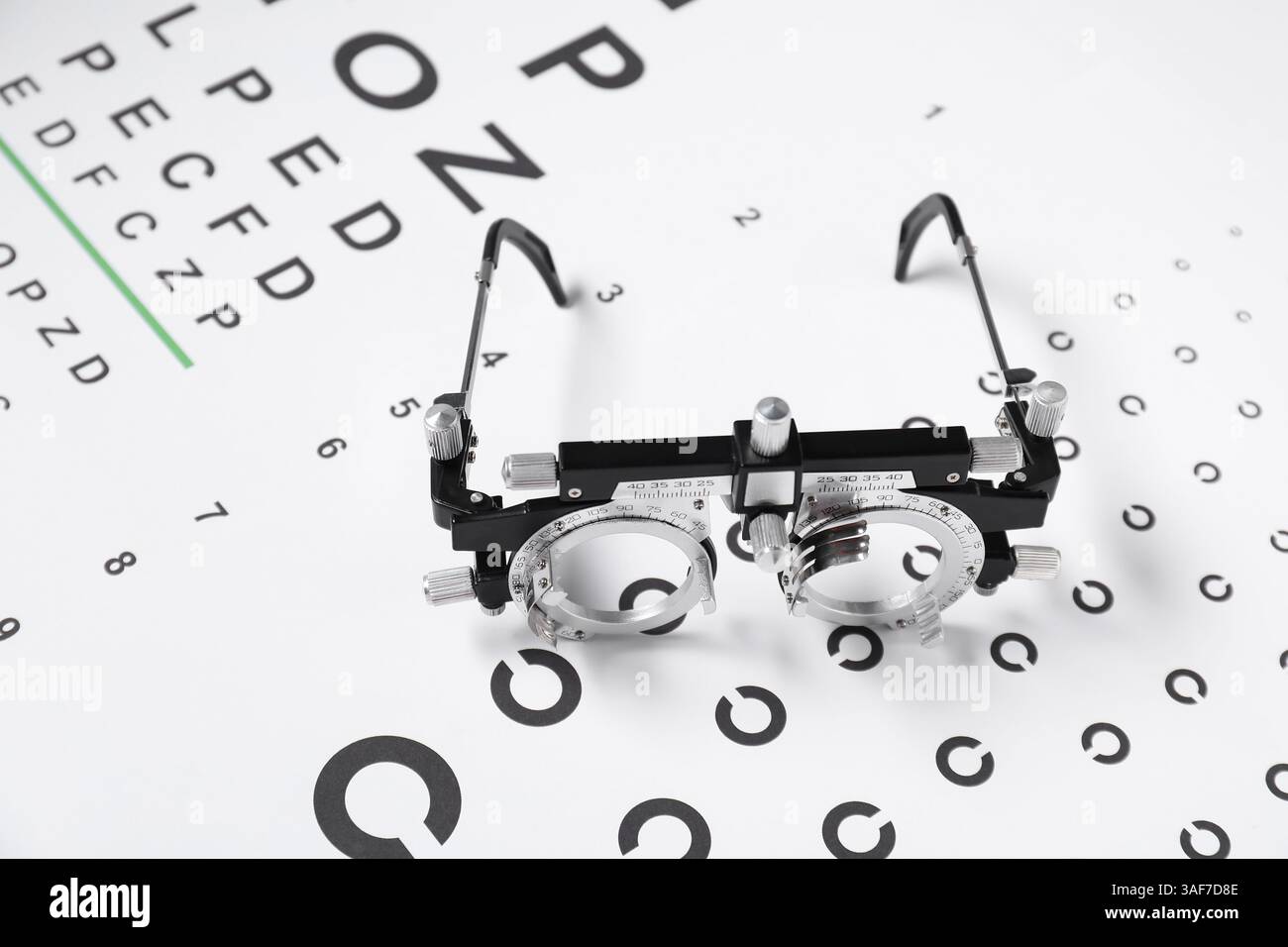 Trial frame on vision test chart, closeup Stock Photo - Alamy