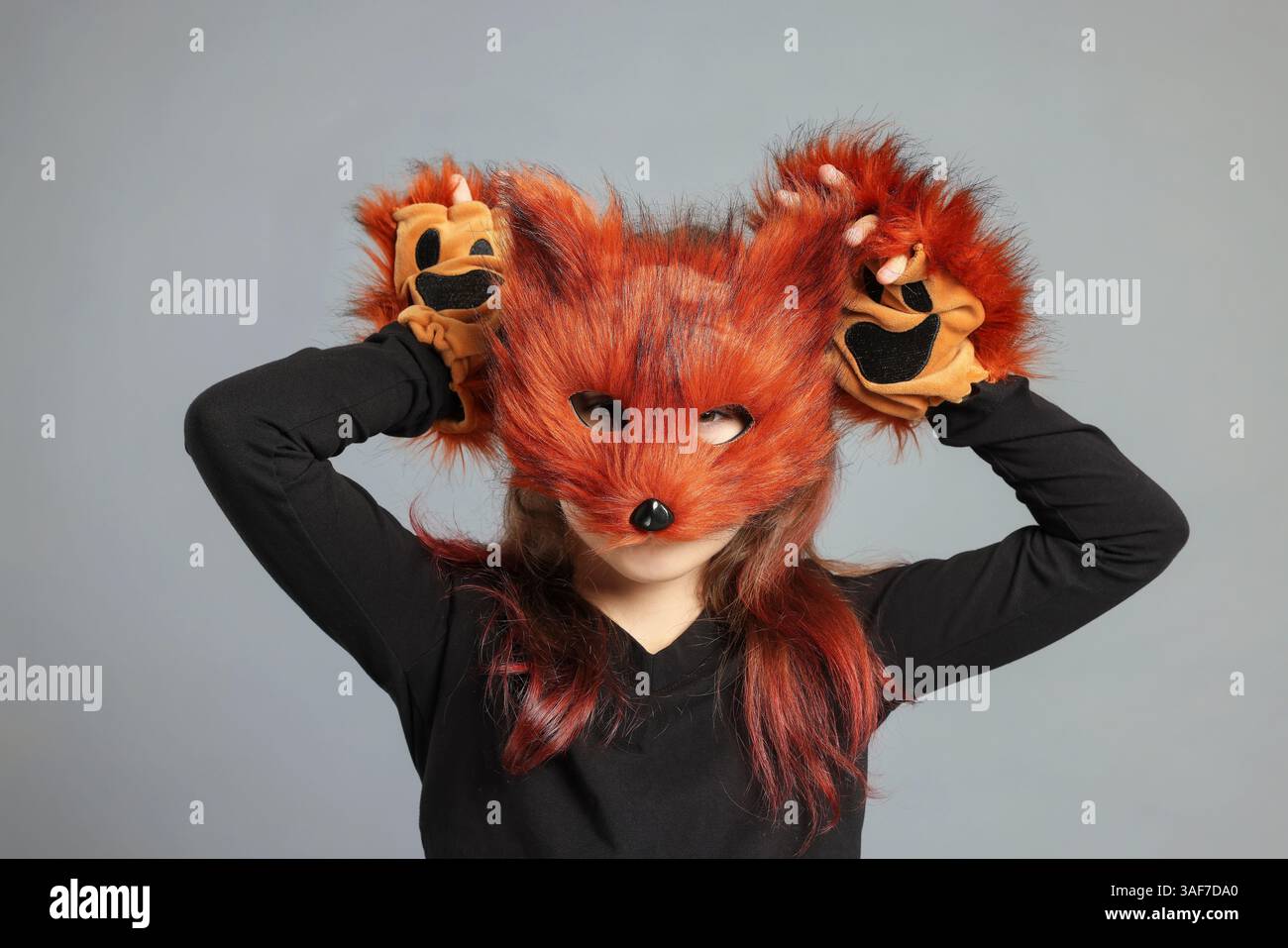 Quadrobics. Girl wearing fox mask and gloves on grey background Stock ...