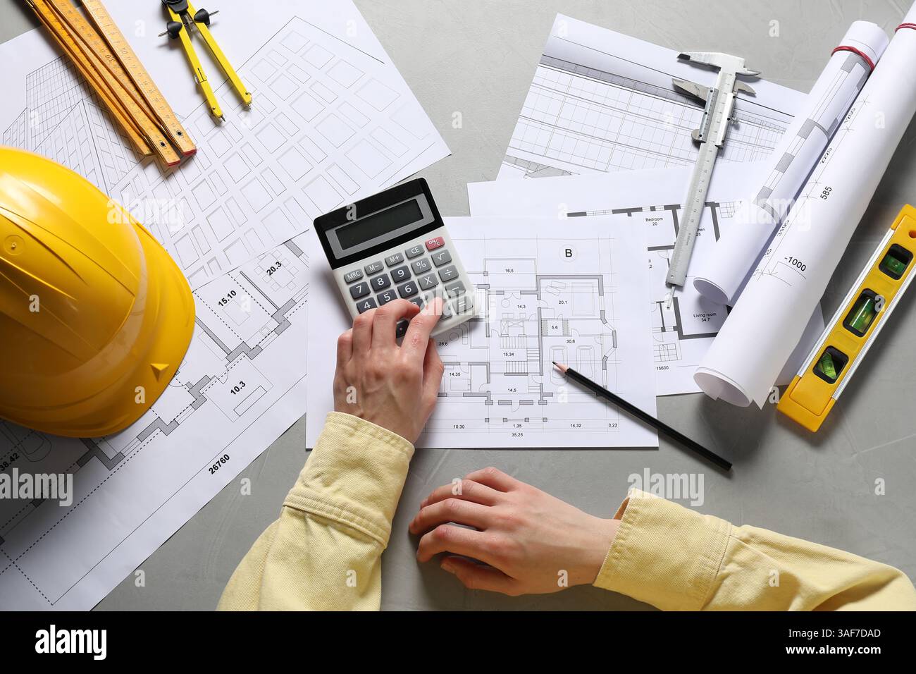 Architect working with project, top view. Different technical drawings ...