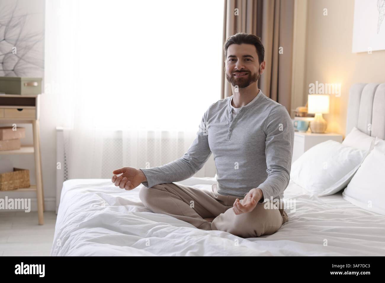 Man meditating on bed hi-res stock photography and images - Alamy