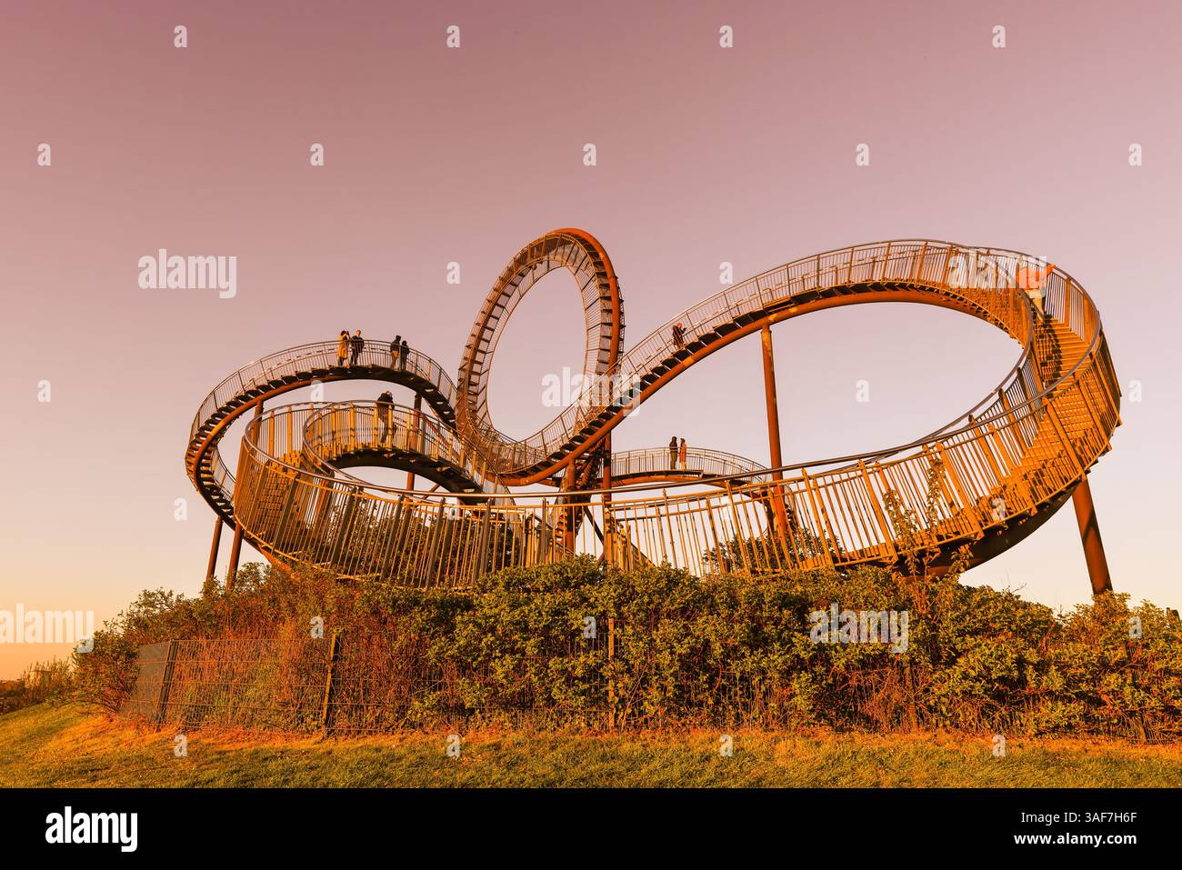 People climb on the 'Tiger and Turtle - Magic Mountain' sculpture ...