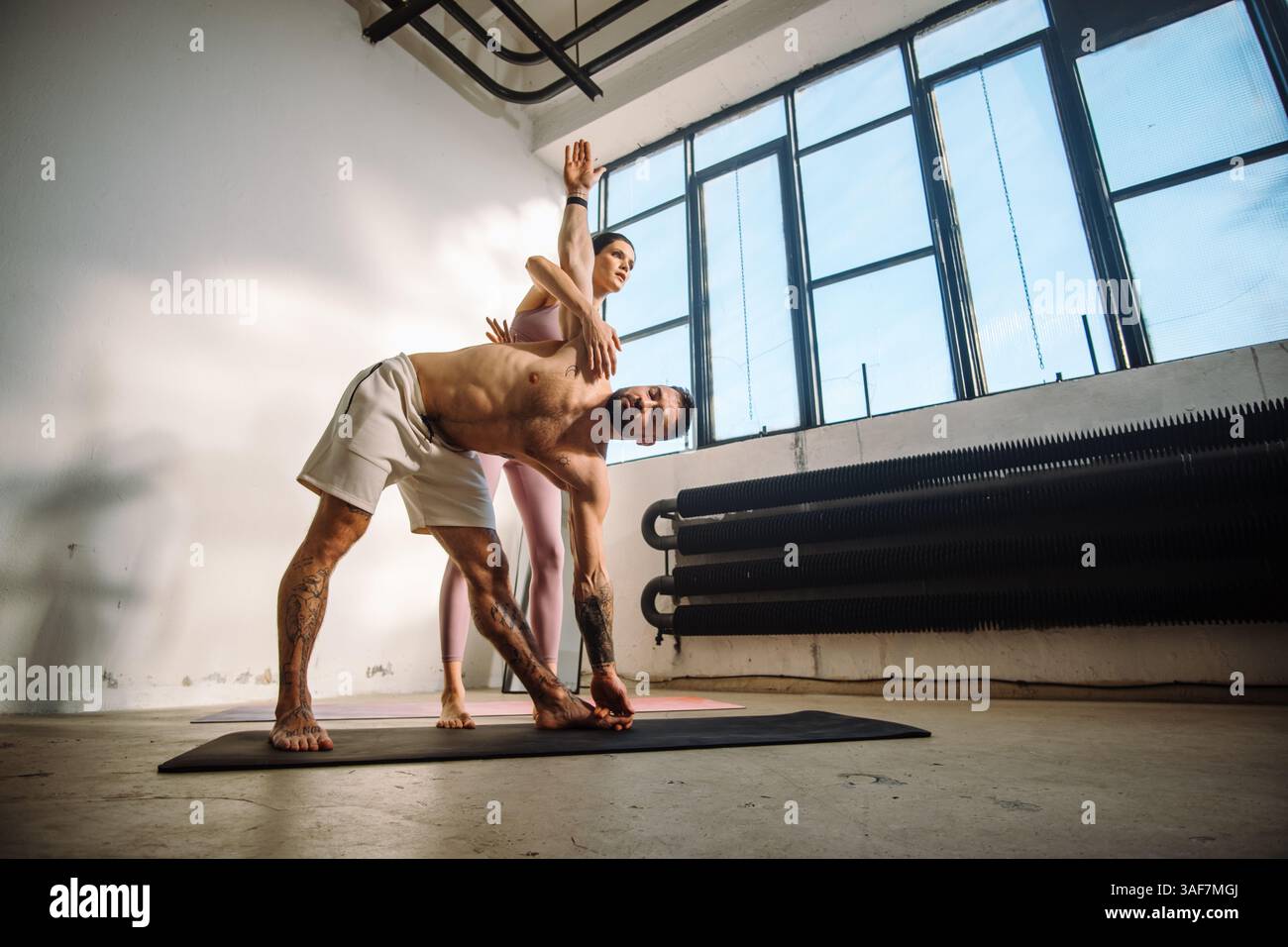 Engaging in Various Dynamic Yoga Poses within a Contemporary Studio ...
