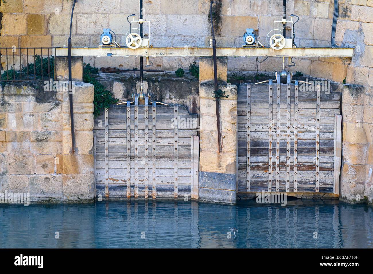Floodgates in a stone wall on the Segura River, an architectural ...