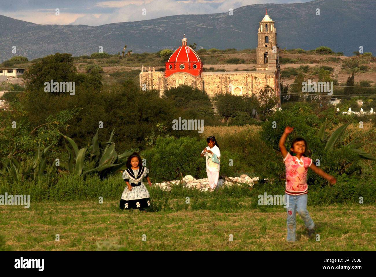 Brigida Ctlanepala, 41, (center) watches sheep and sews as her children ...
