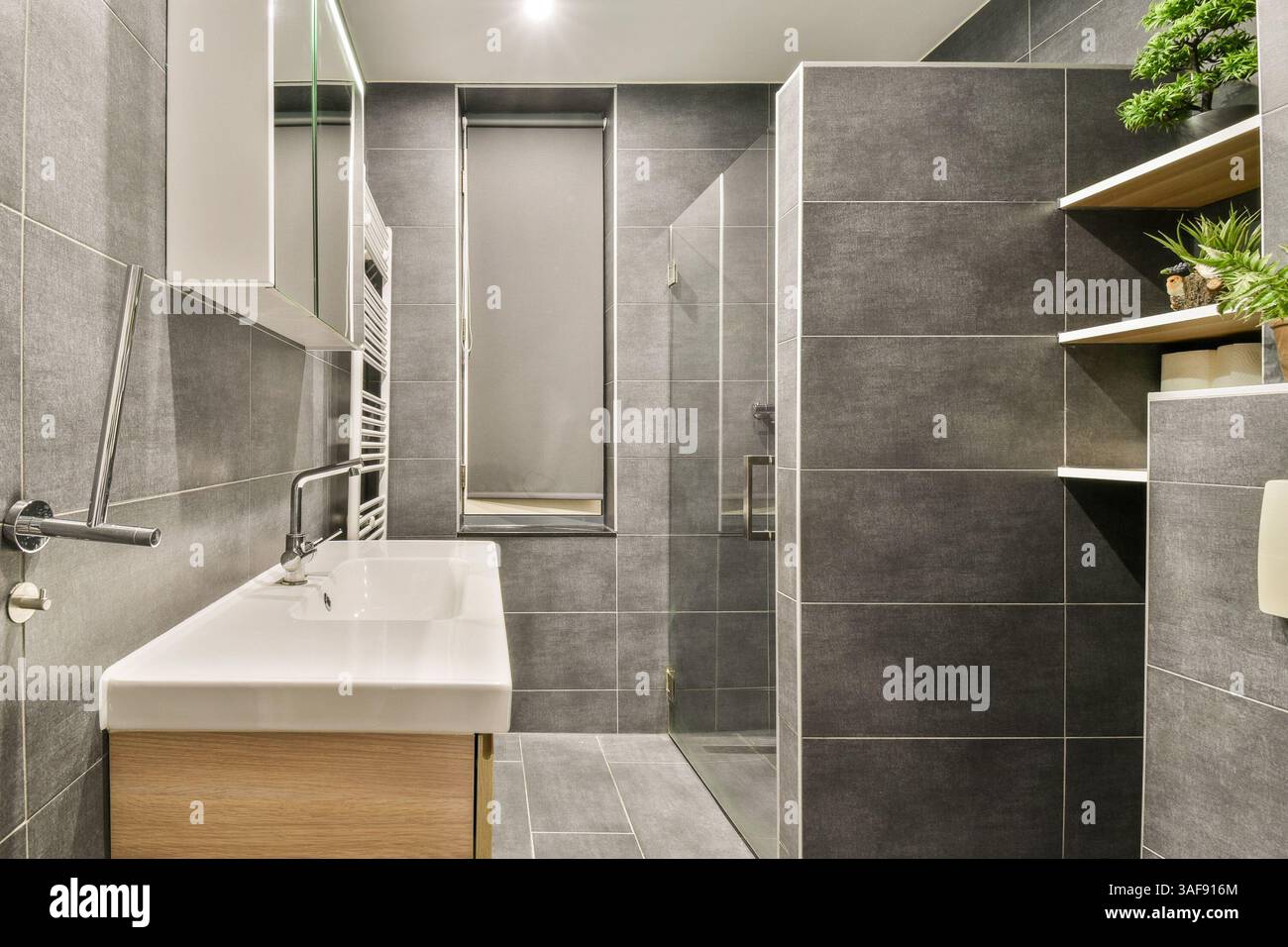 Elegant modern bathroom featuring sleek grey tiles, contemporary ...