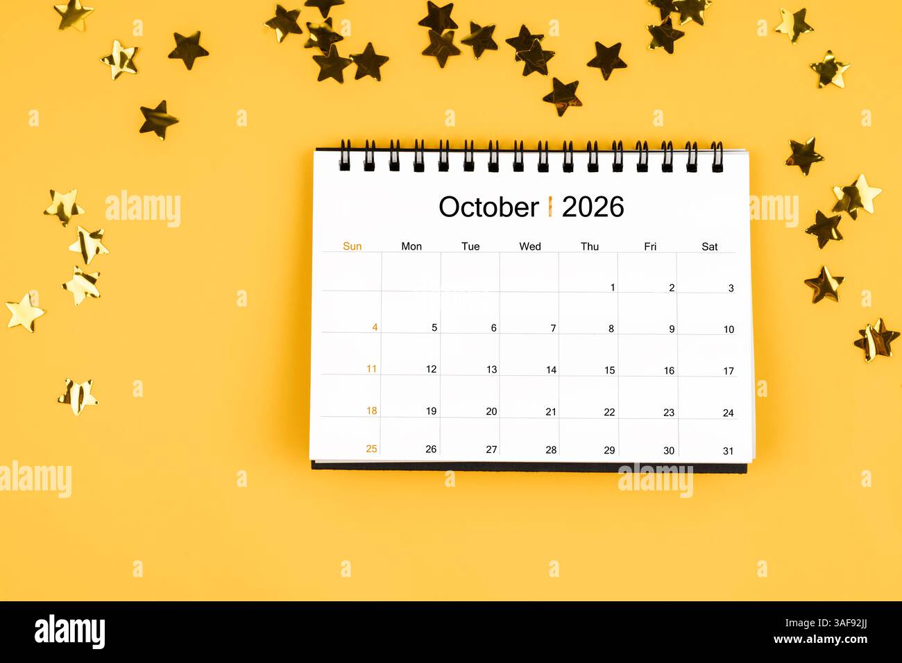 October 2026 calendar and scattered sparkling yellow confetti stars on ...