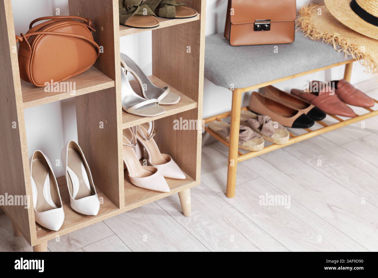 Stands with different stylish shoes, straw hats and bags indoors Stock ...