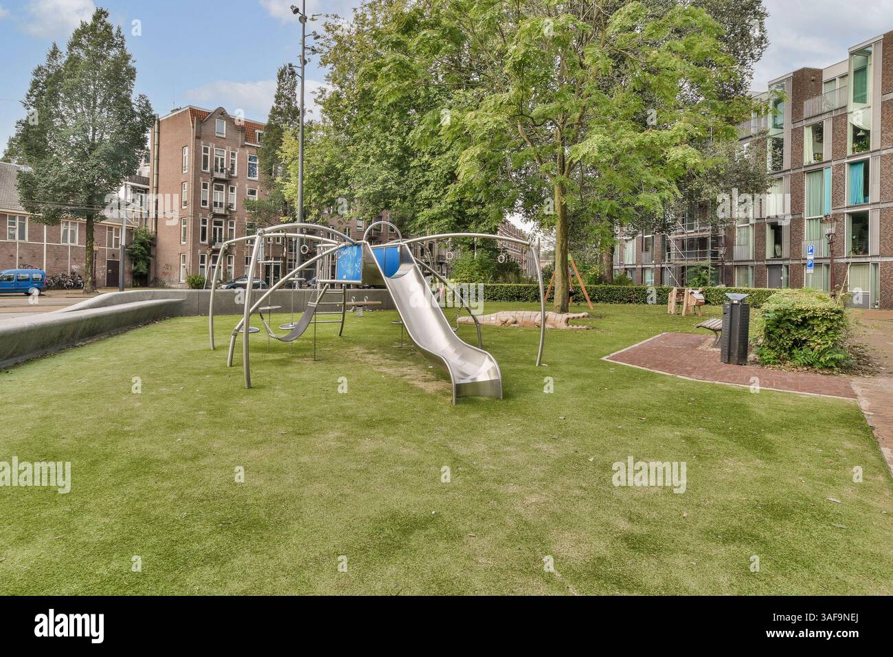 A colorful playground featuring a slide, surrounded by lush greenery ...