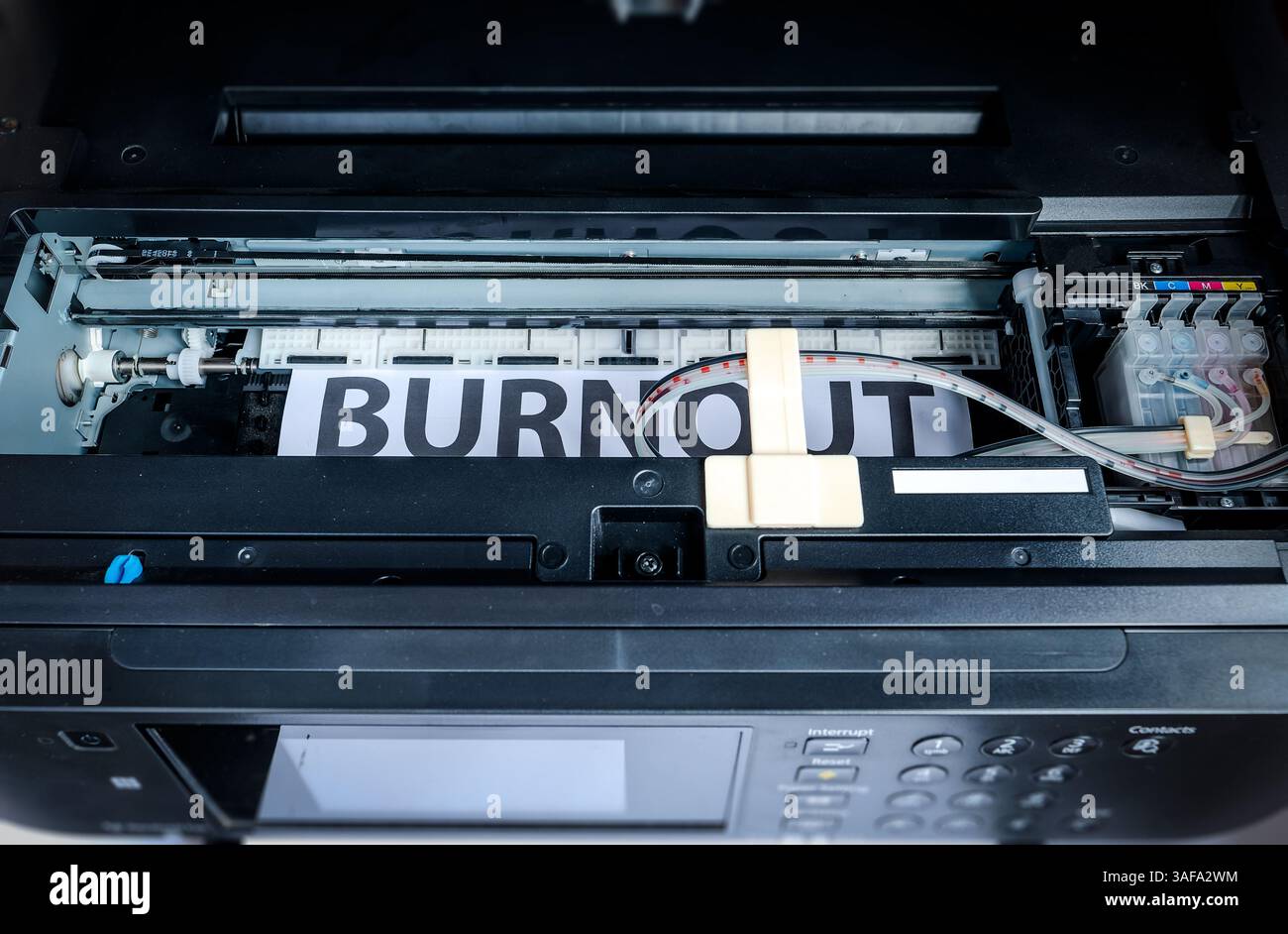 Photo of a printer jamming a sheet labeled burnout at the output tray ...