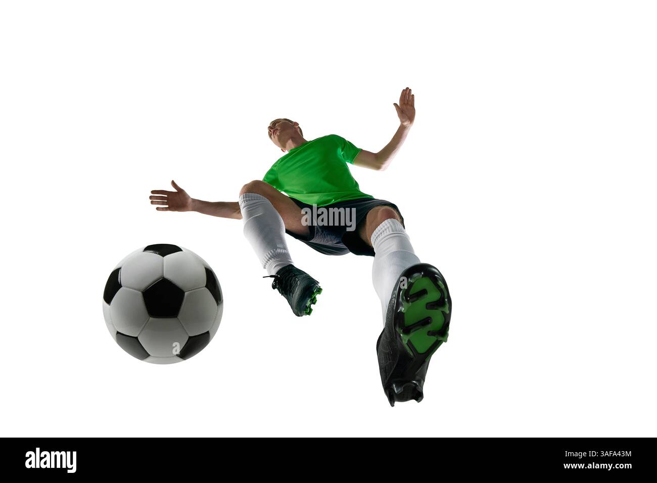 Low angle of young man, dressed sport uniform, soccer player training ...