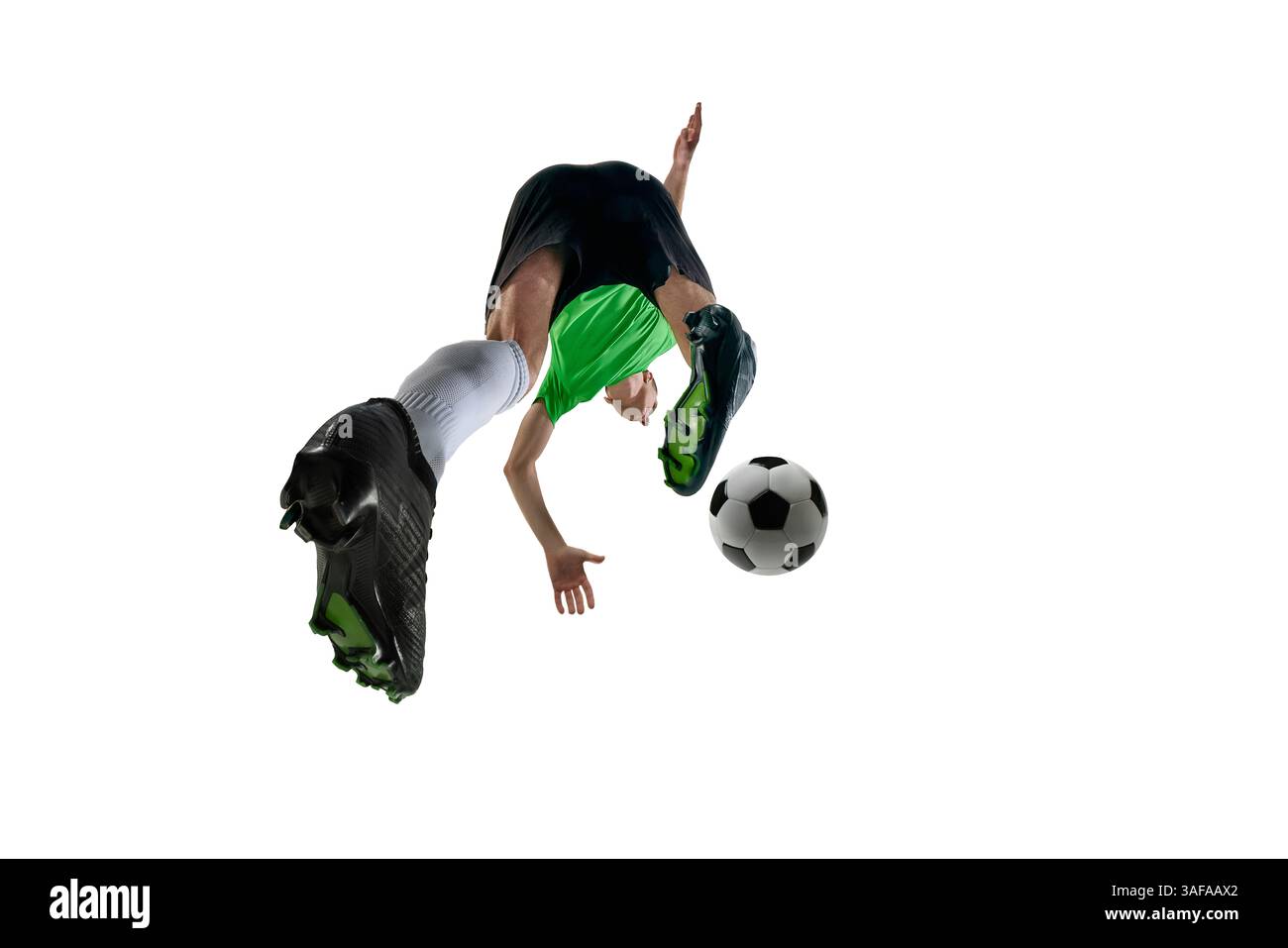 Low angle of dynamic man, dressed sport uniform, soccer player shooting ...