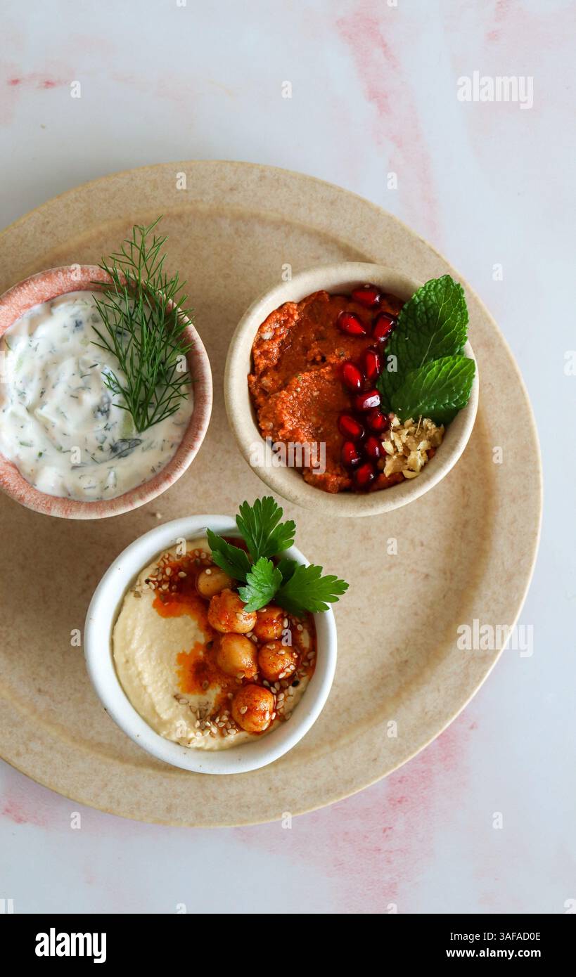 Trio of middle eastern dips, different colours and flavours on a white ...