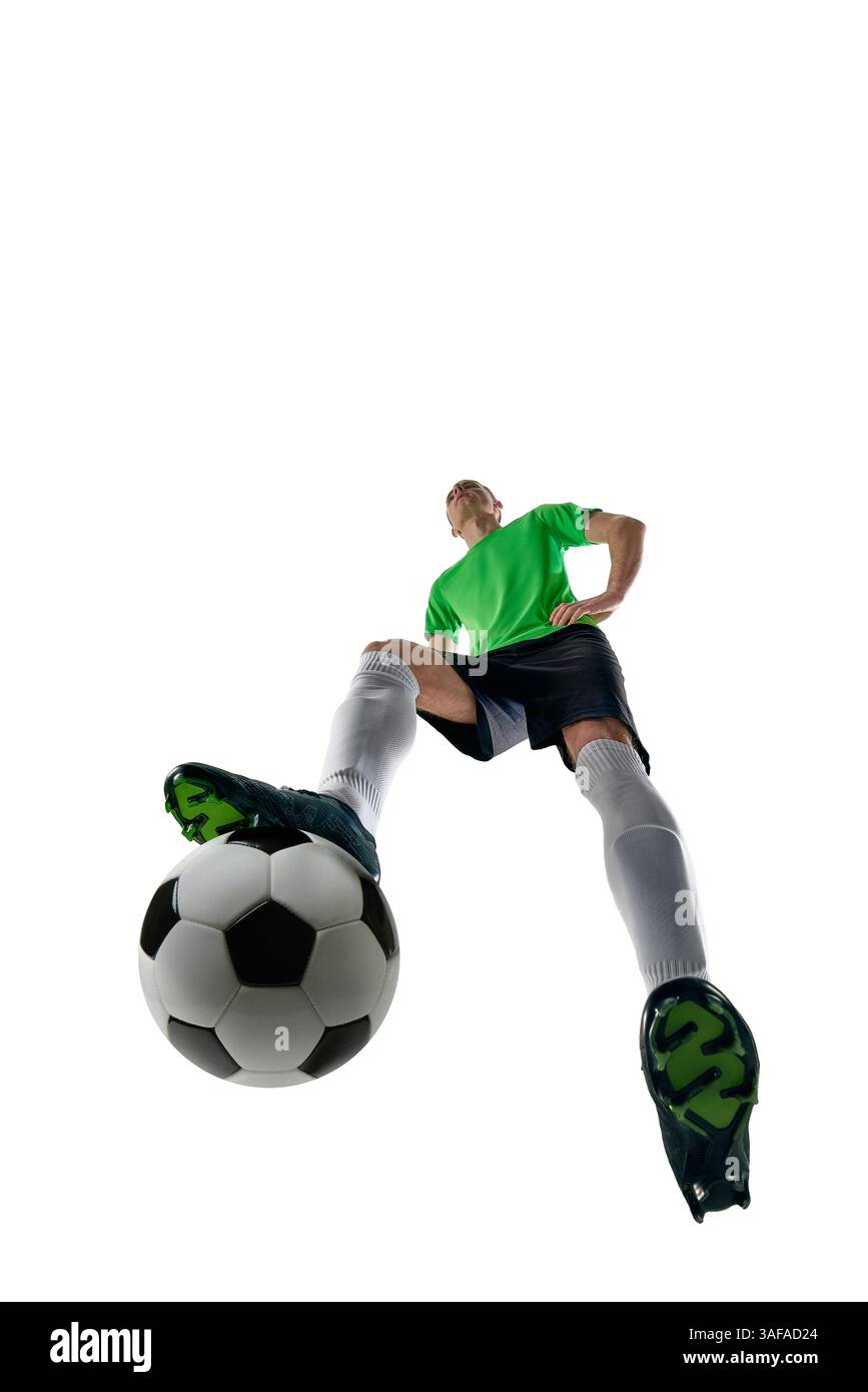 Low angle of skilled man, dressed sport uniform, soccer player ...