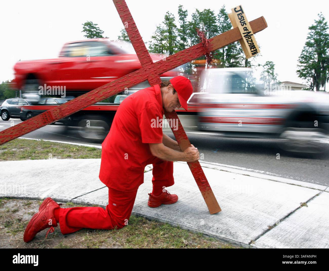 CAPTION: (Wesley Chapel, May 3, 2007) #1..John Obadiah Franklin kneels ...