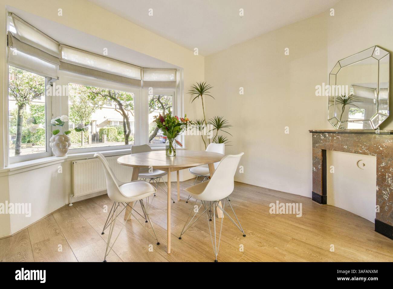 Bright and airy modern interior featuring a stylish table and chairs ...