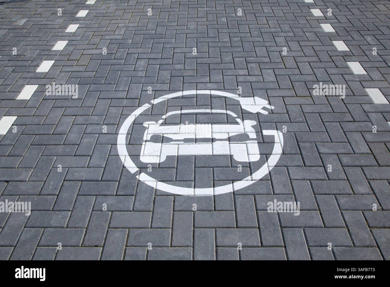 EV charging bay symbol marked on ground paving Stock Photo - Alamy