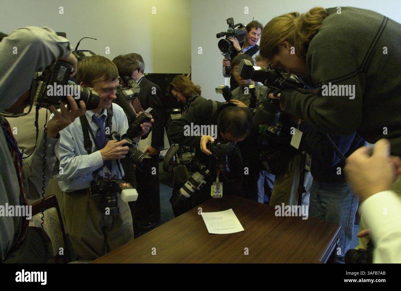 Press photographers close in for a shot of the subpoena issued for ...