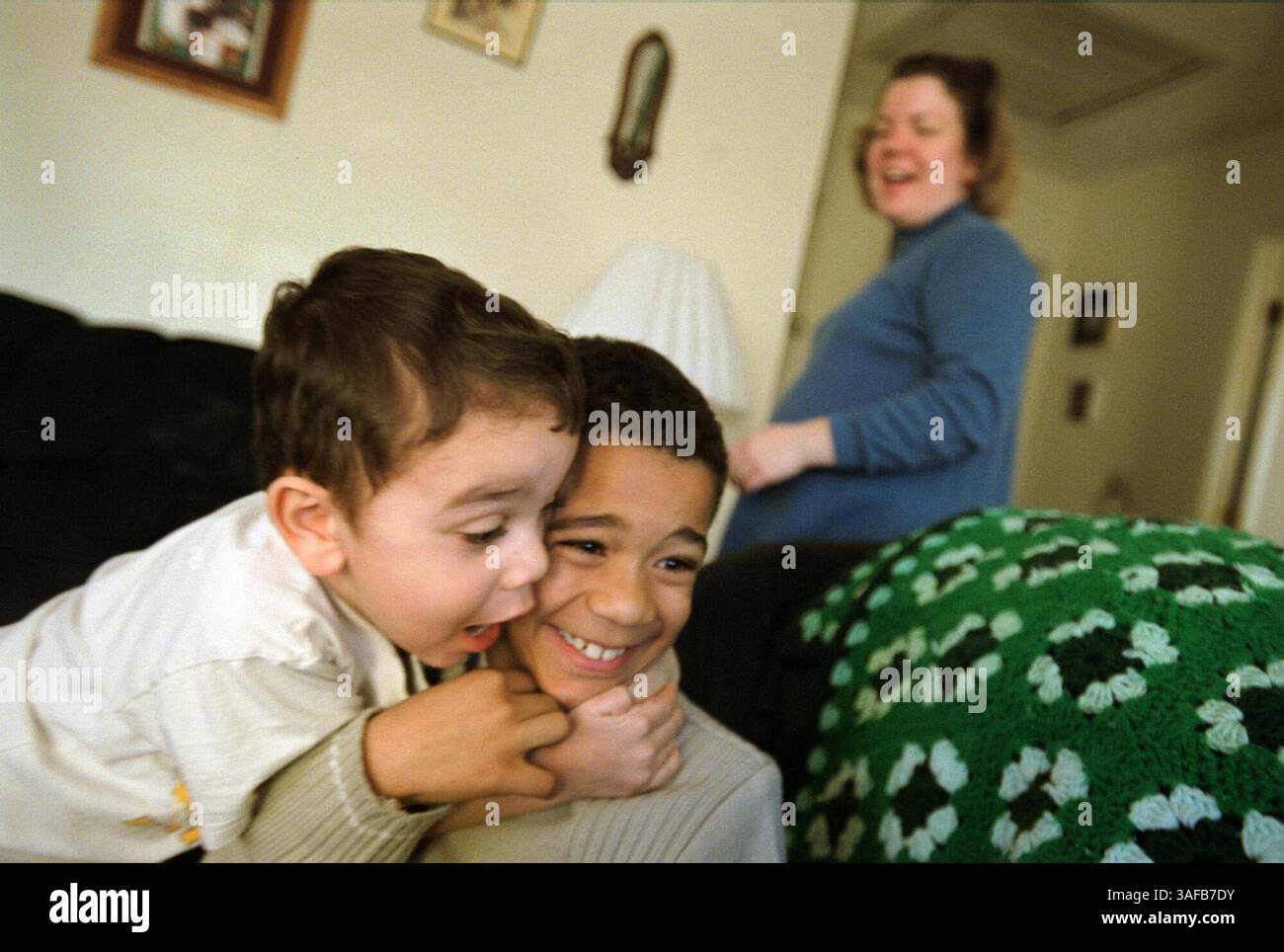 Four year old ''DJ'' Butler, grabs his big brother Steven, 8, while ...