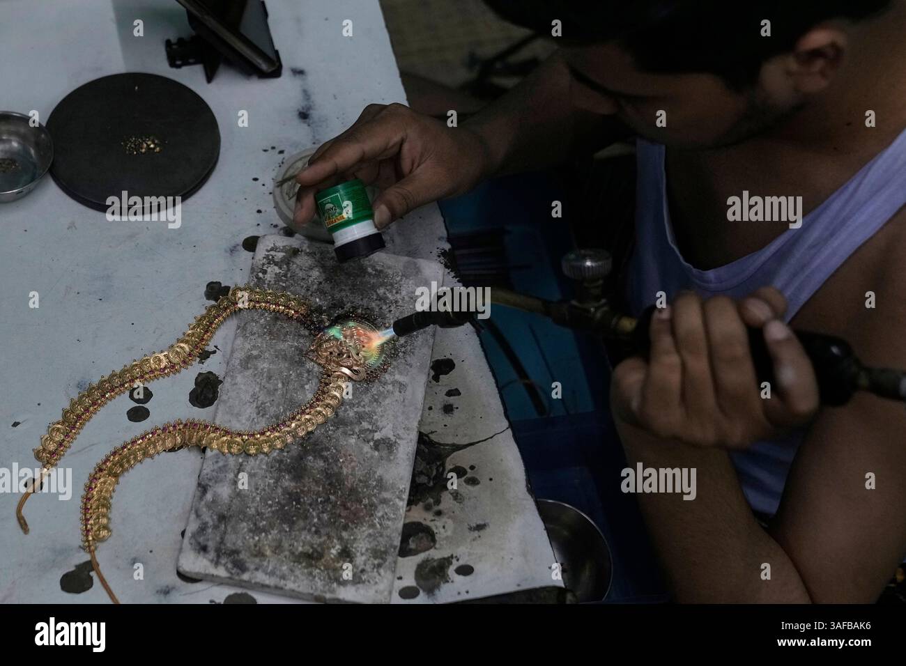 An Indian goldsmith makes jewelry in Hyderabad, India, Monday, April 7 ...