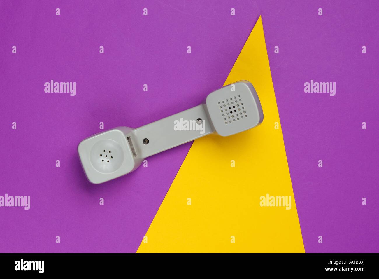 Three Retro telephone handset on colored paper background with ...