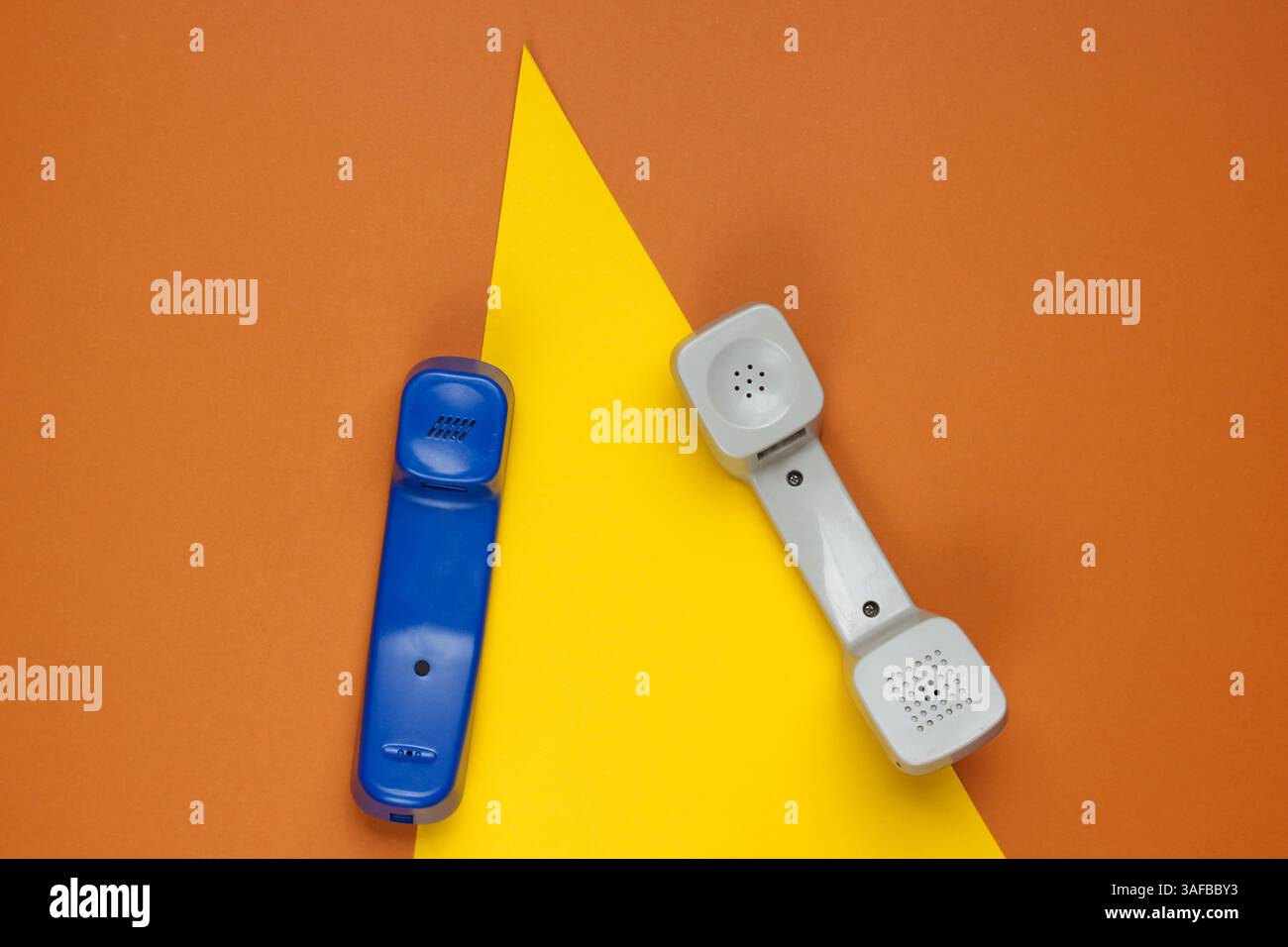 Three Retro telephone handset on colored paper background with ...