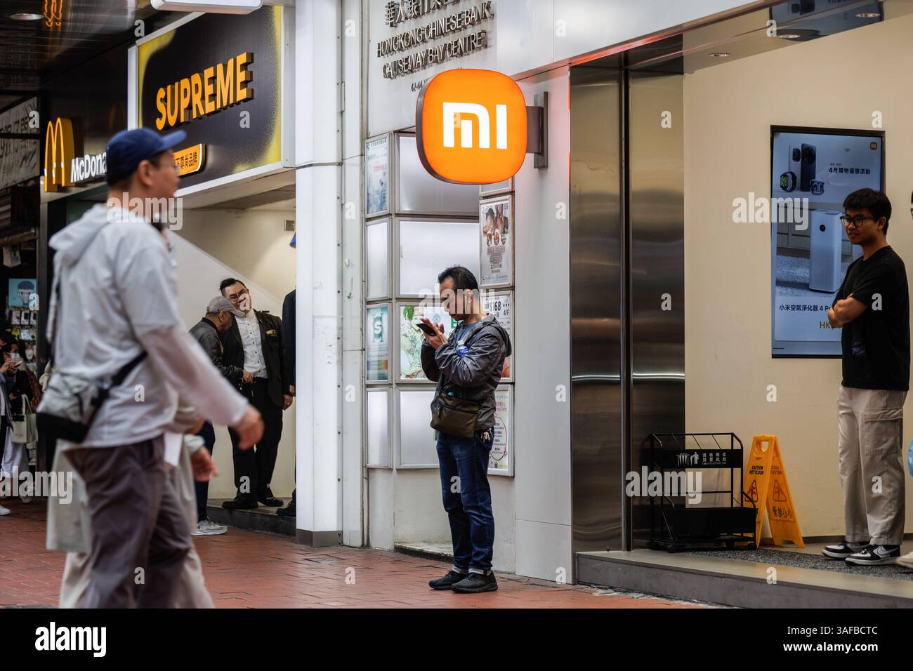 Hong Kong, China. 06th Apr, 2025. A man looks at his phone outside ...