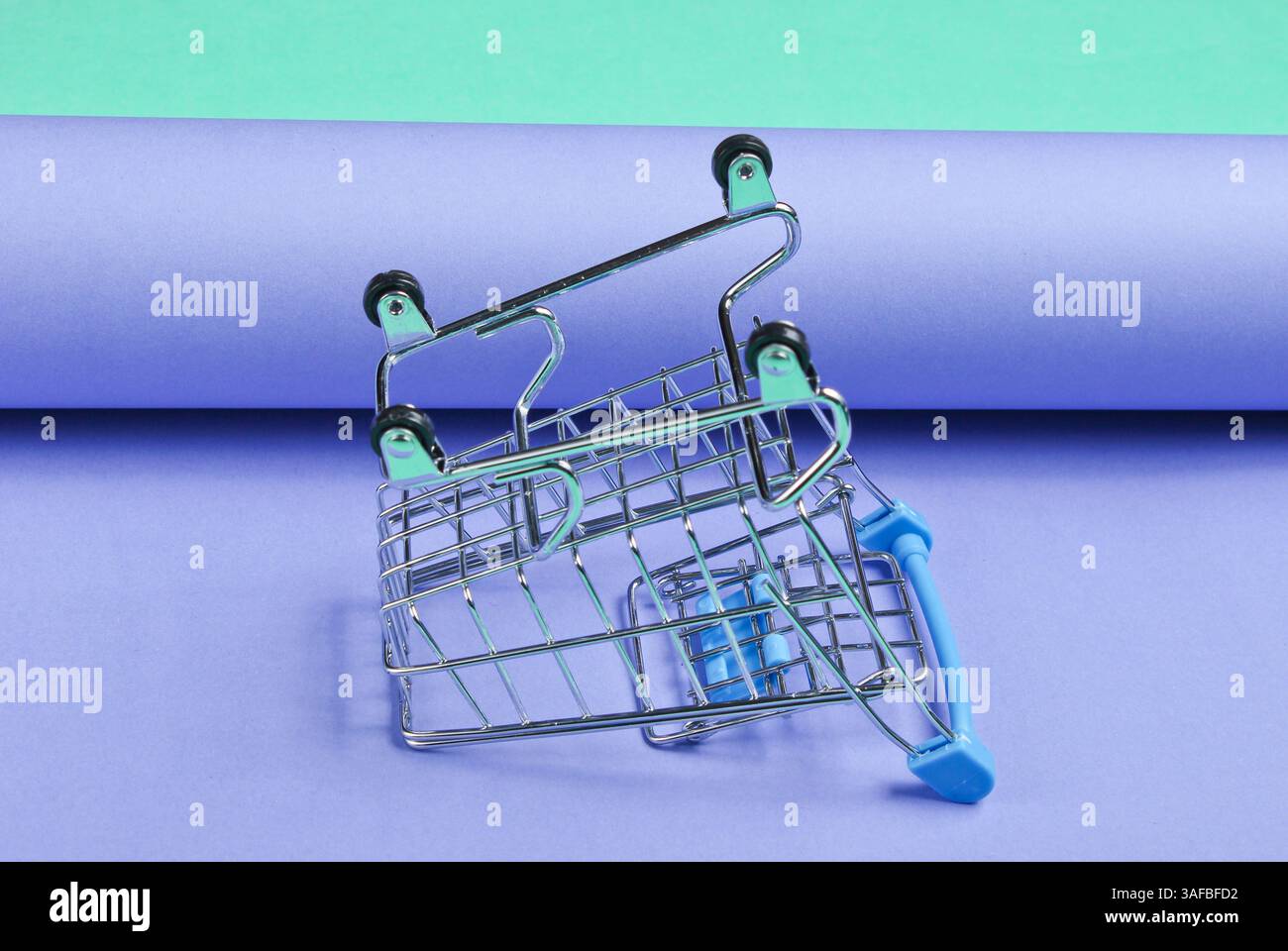 Shopping cart on wrapped paper background. Color trend, minimalistic ...