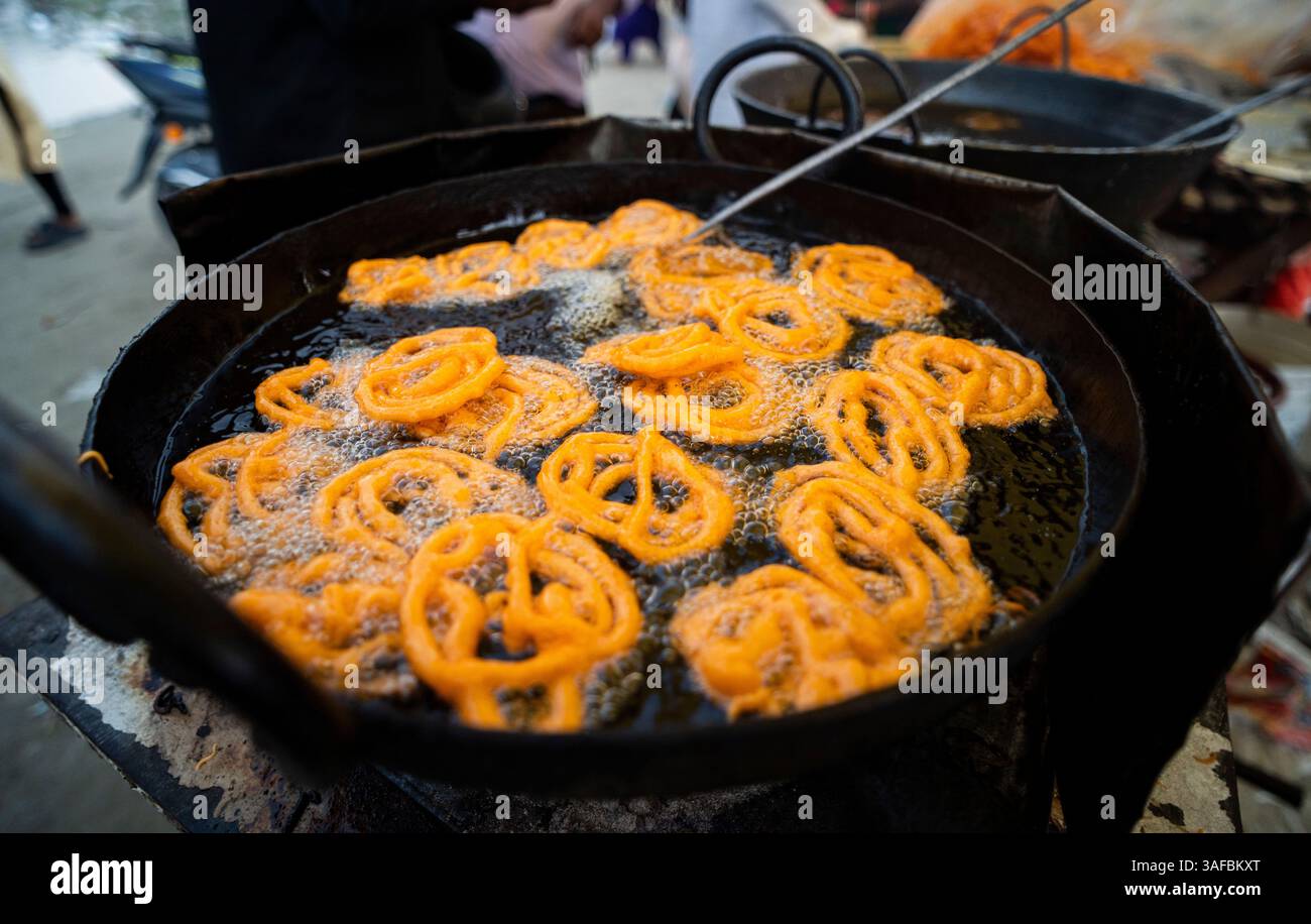 April 5, 2025: Vendor makes Jalebi on the bank of Brahmaputra river on ...
