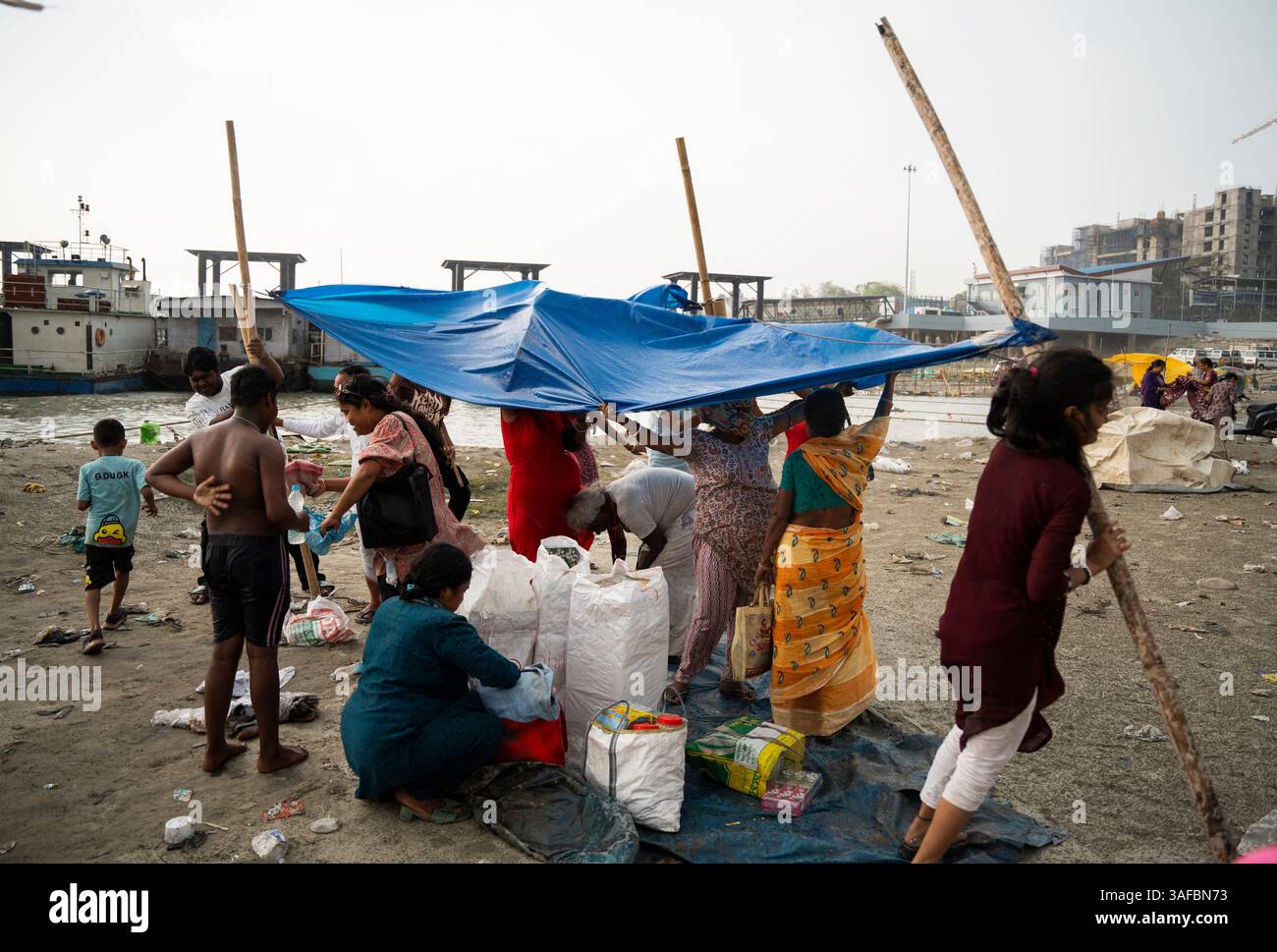 April 5, 2025: GUWAHATI, INDIA - APRIL 5: Women holds a plastic tarp ...
