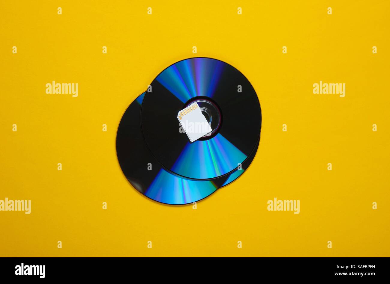 SD memory card, cd drives on yellow paper background. Modern and ...