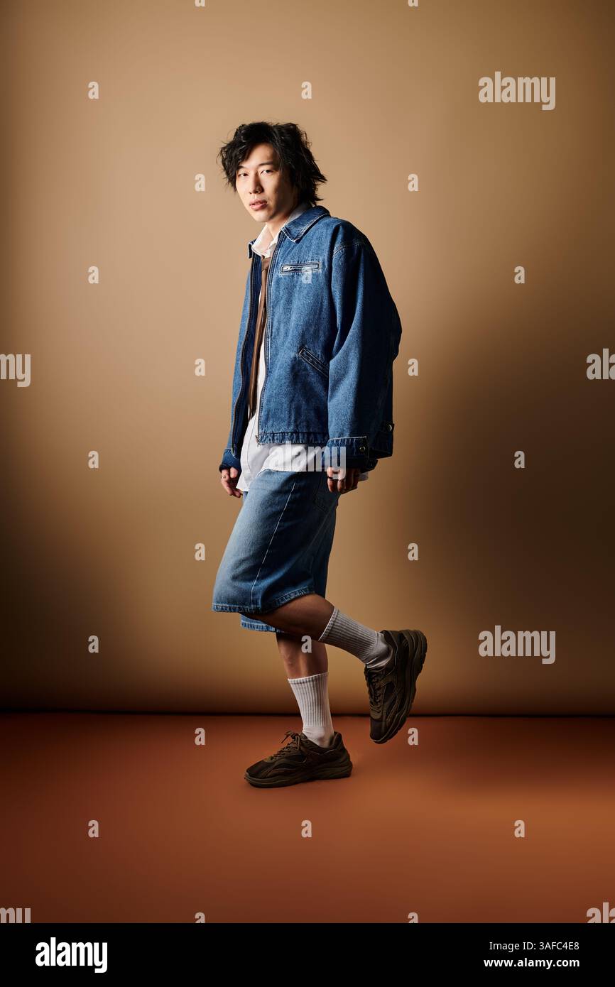 An asian man models trendy spring attire in a modern studio, capturing ...