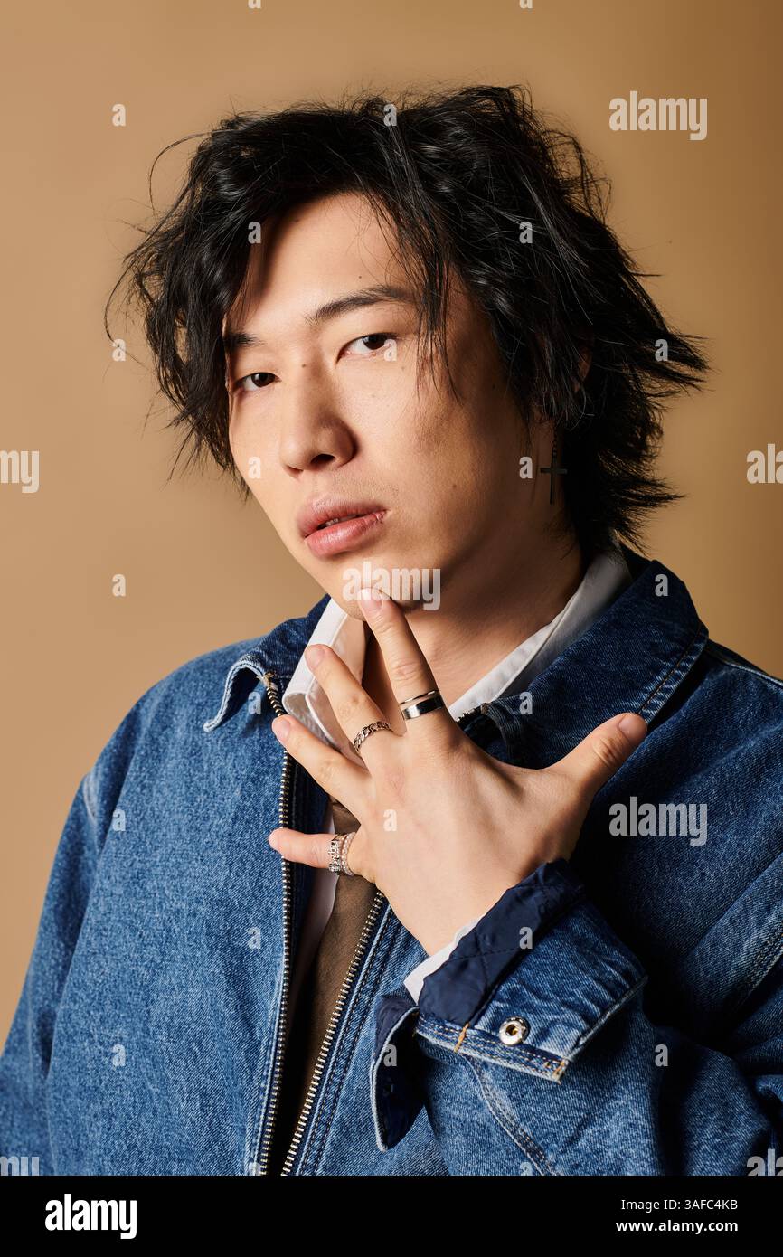 A stylish Asian male model displays contemporary spring clothing trends ...