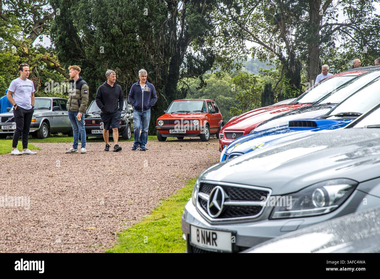 Bristol, UK- August 13, 2023: Cars parked in row and people at the car ...
