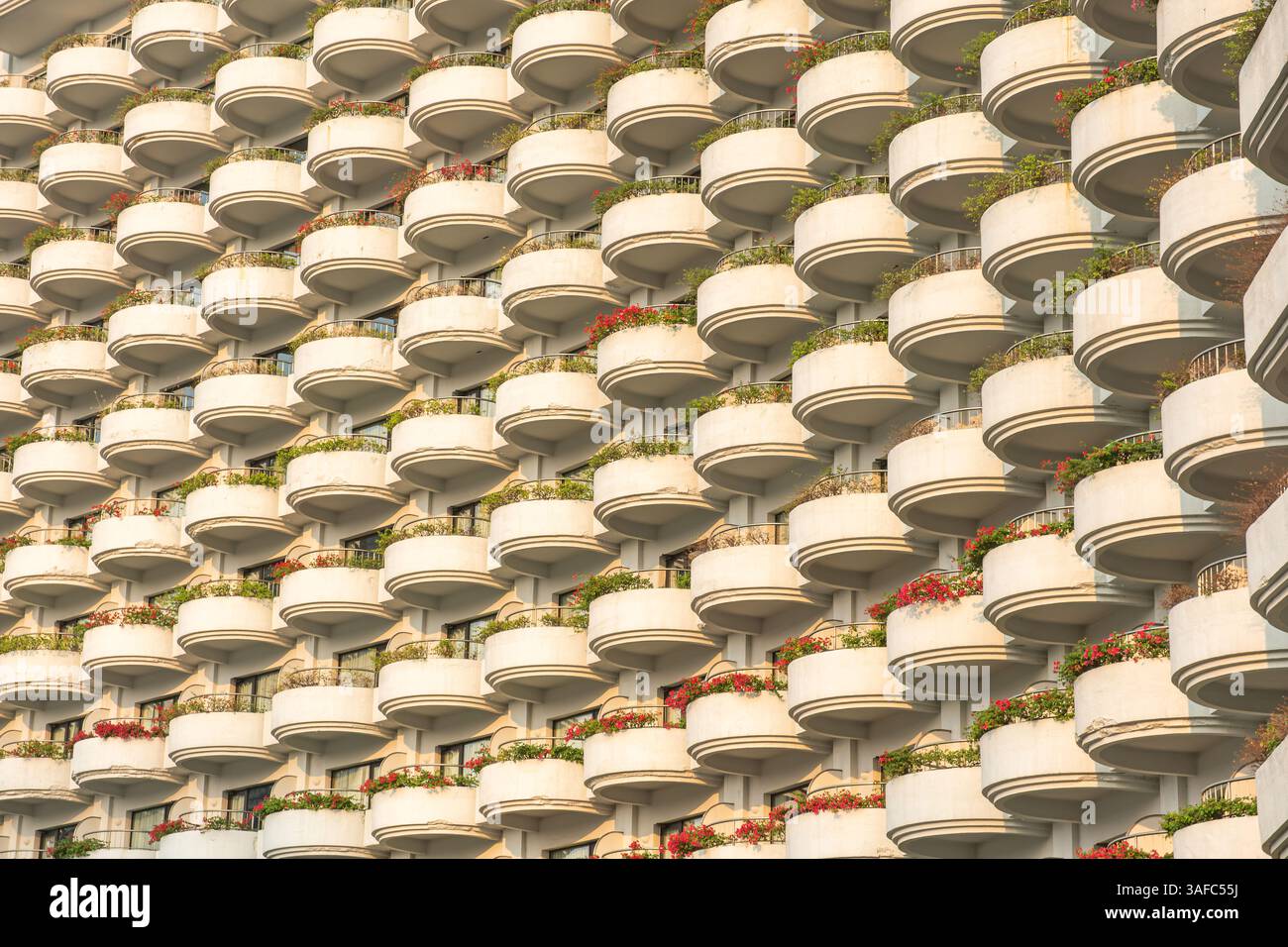 Repetitive pattern of rounded balconies on residential building facade ...