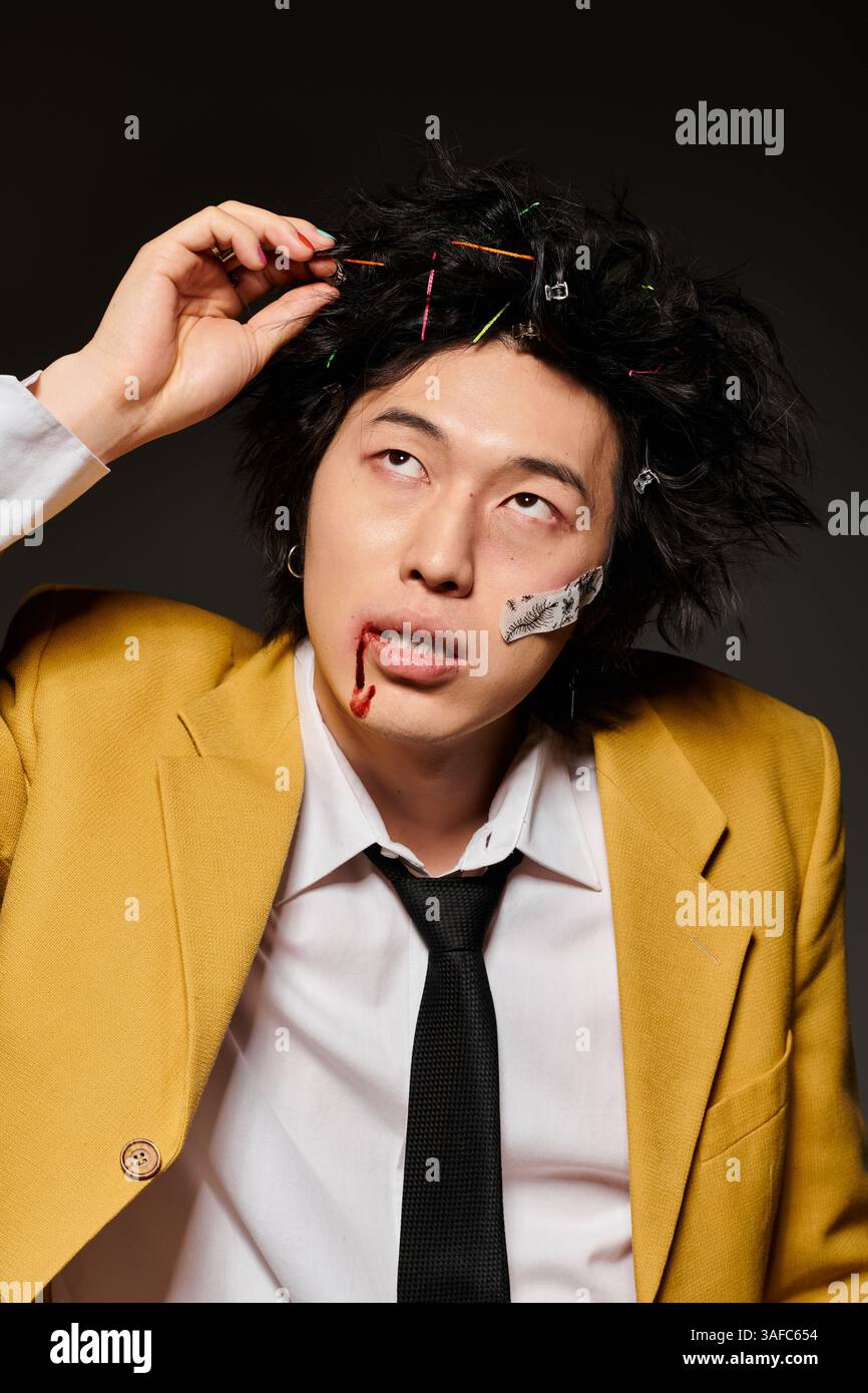 Stylish asian man with blood on face showcases unique fashion in a ...