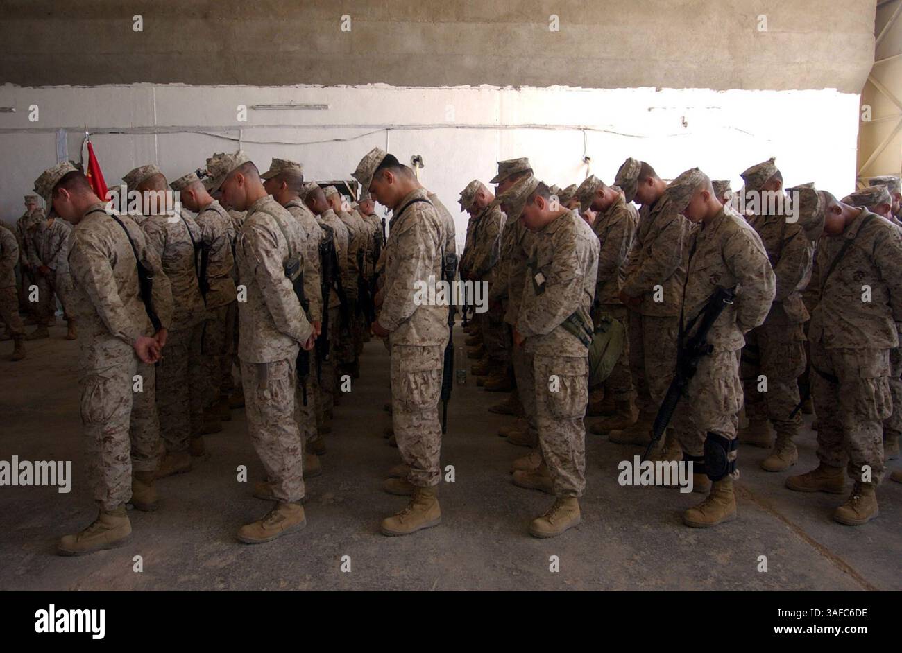 Apr 11, 2004; Ar Ramadi, Iraq; Marines lined in a formation bow their ...