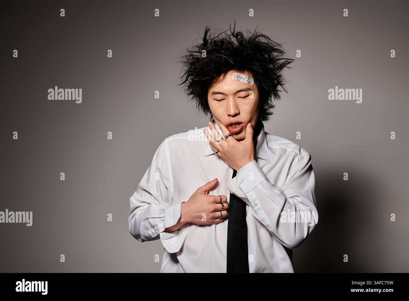 An Asian man in stylish clothes toughing face after fight Stock Photo ...