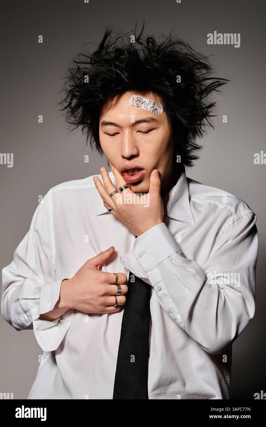 An Asian man feeling hurt after fight showcases his style with a unique ...